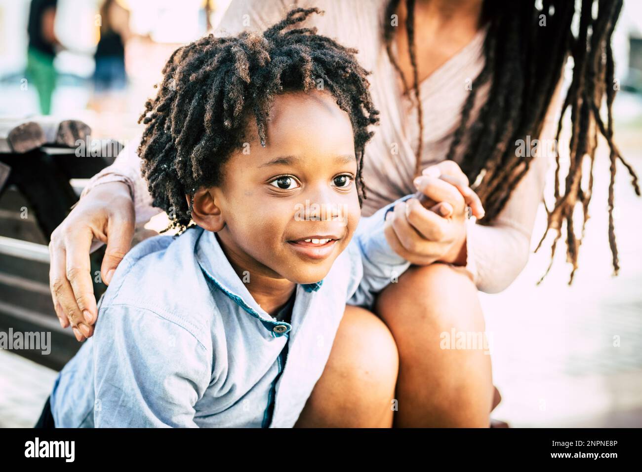 Portrait close up of little guy enjoying time outdor with his mommy ...