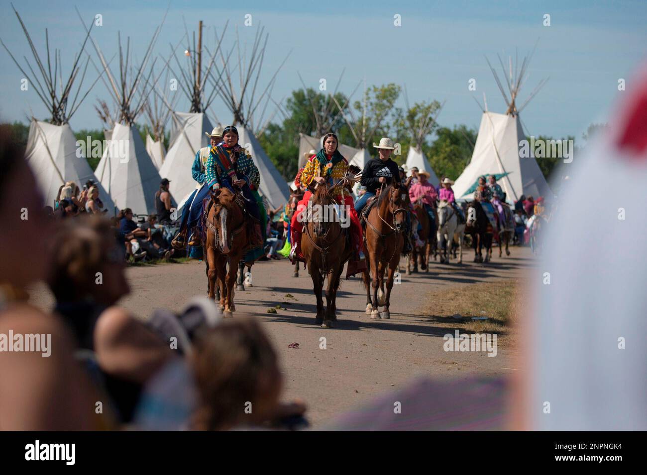 Participants ride in the morning parade at Crow Fair in Crow Agency ...
