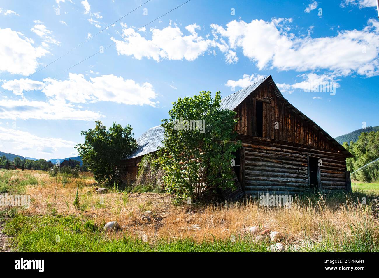 Sprinklers water the ground next to the barn at Glassier Open Space in ...