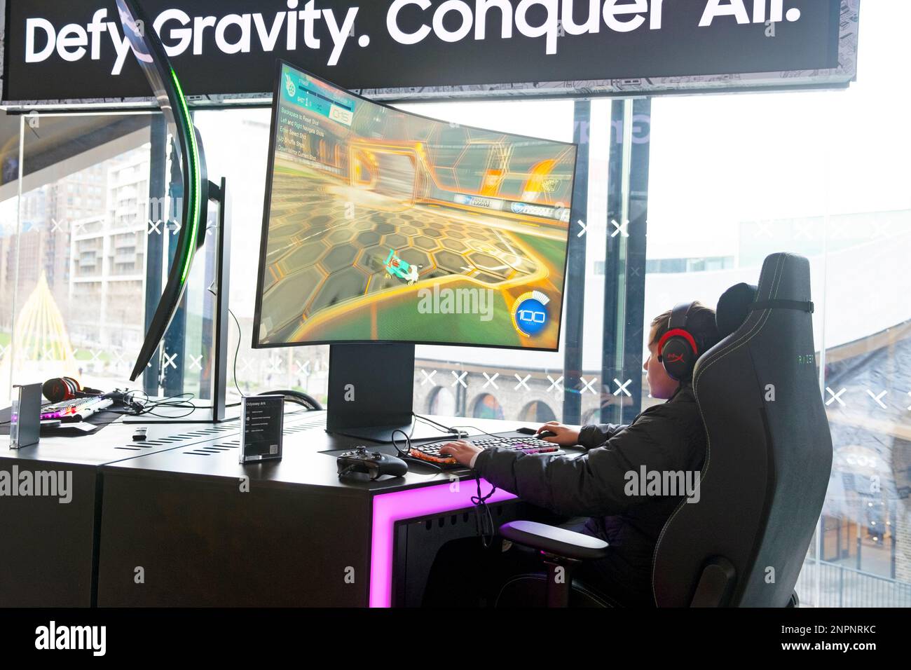 Teenage boy child teen playing video game games on Samsung KX Gaming Bus at the Concept Store in ...