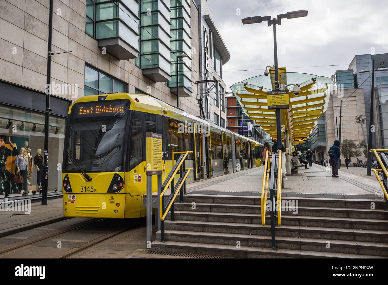 A yellow and grey Metrolink tram stopping at Corporation Street in ...
