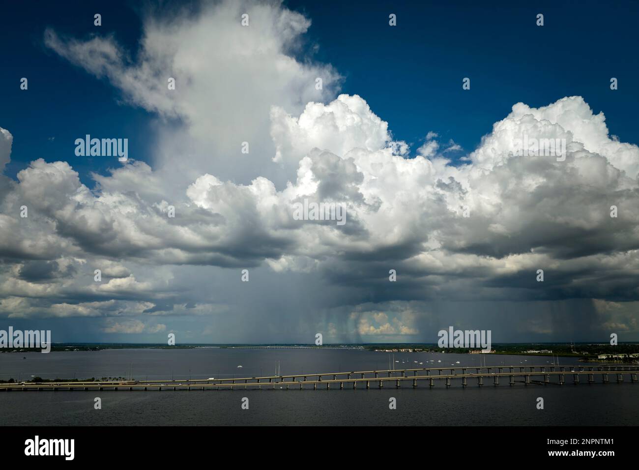 Stormy clouds forming from evaporating humidity of ocean water before ...