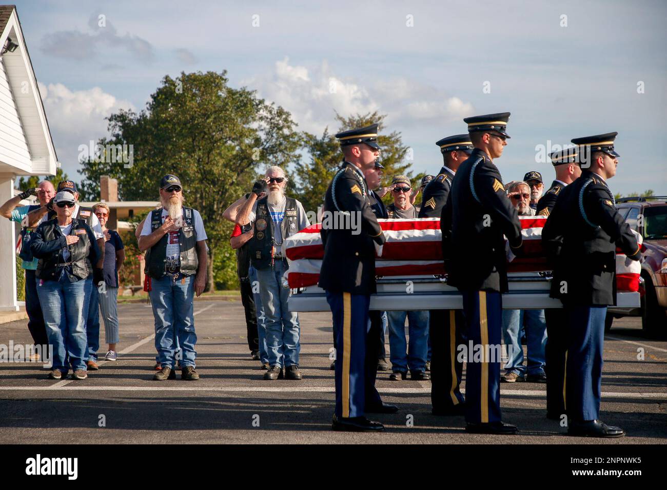 Patriot Guard Riders salute as military members carry the casket of ...