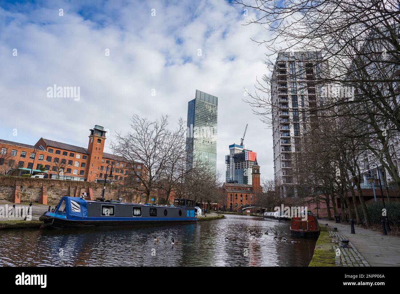Narrow boats seen down the BridgeWater Way towpath in the Castlefield ...
