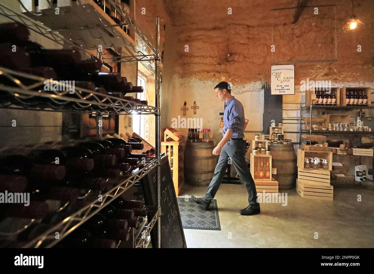 Displays of bottled wine and locally-produced specialty food items ...