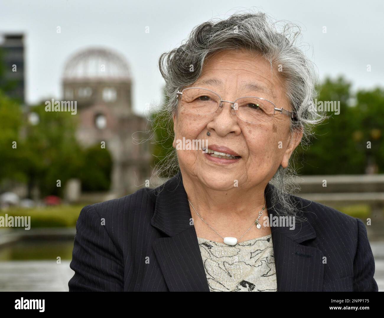 Koko Kondo speaks at Hiroshima Peace Memorial Park with a backdrop of ...