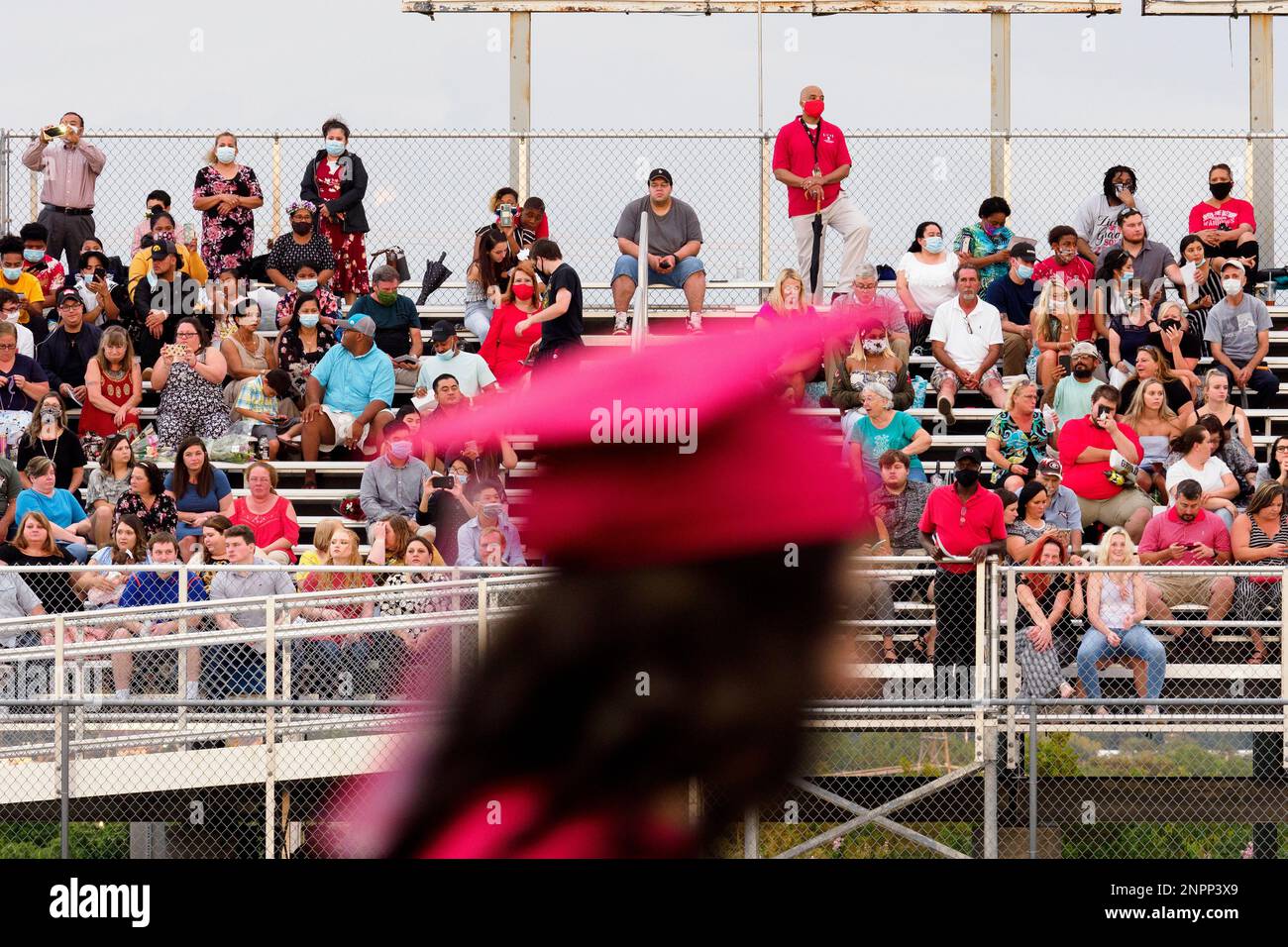 The crowd looks on as the students enter the stadium for the ...