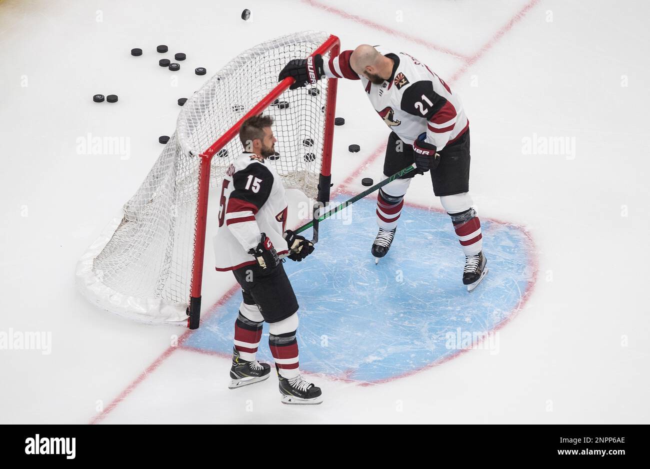 Arizona Coyotes' Brad Richardson (15) and Derek Stepan (21) grab pucks ...