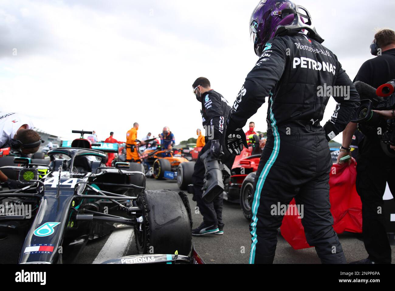 Mercedes driver Lewis Hamilton of Britain inspects puncture on his car ...