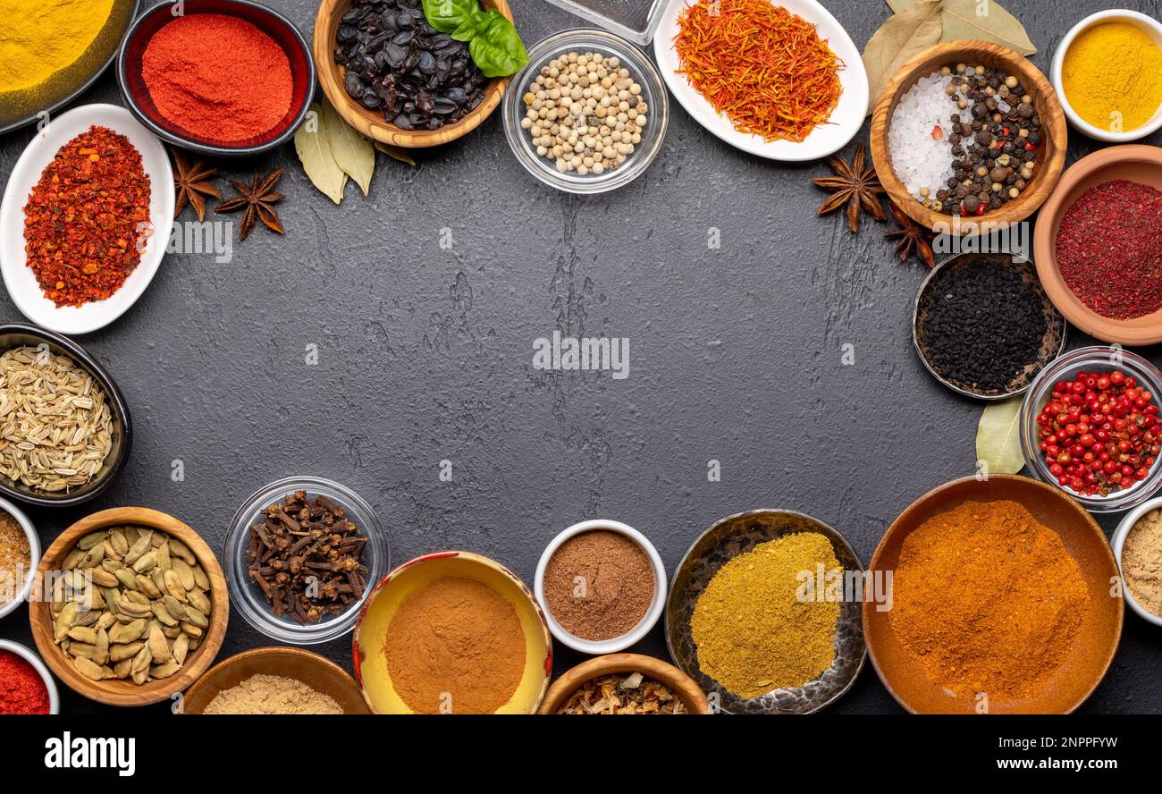 Various spices in bowls on stone table. With copy space for your menu ...