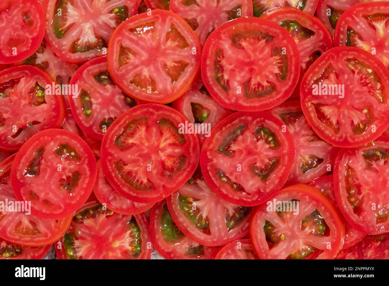 Tomato slices. Natural background with slices of tomato Stock Photo - Alamy