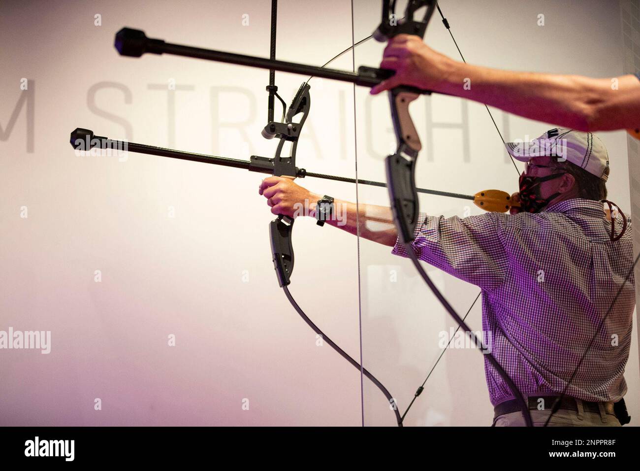 Troy Gray, from Elizabeth, tests out an interactive archery simulation ...