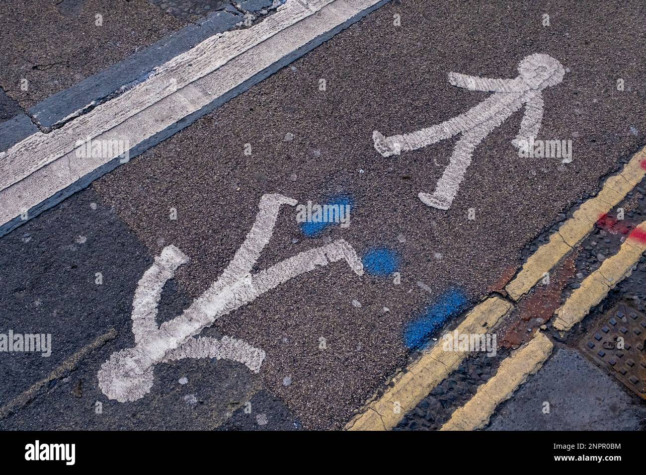Pedestrian figures painted on the road beside double yellow lines on ...