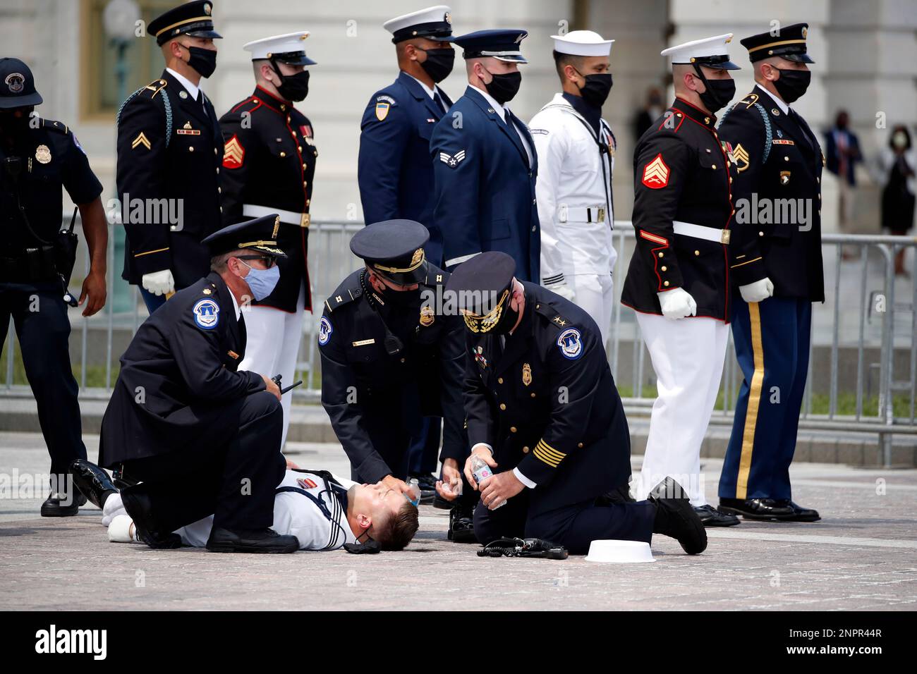 U.S. Capitol Police officers tend to a member of the joint services ...