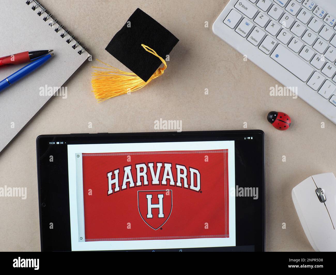 In this photo illustration, Harvard University logo seen displayed on a ...