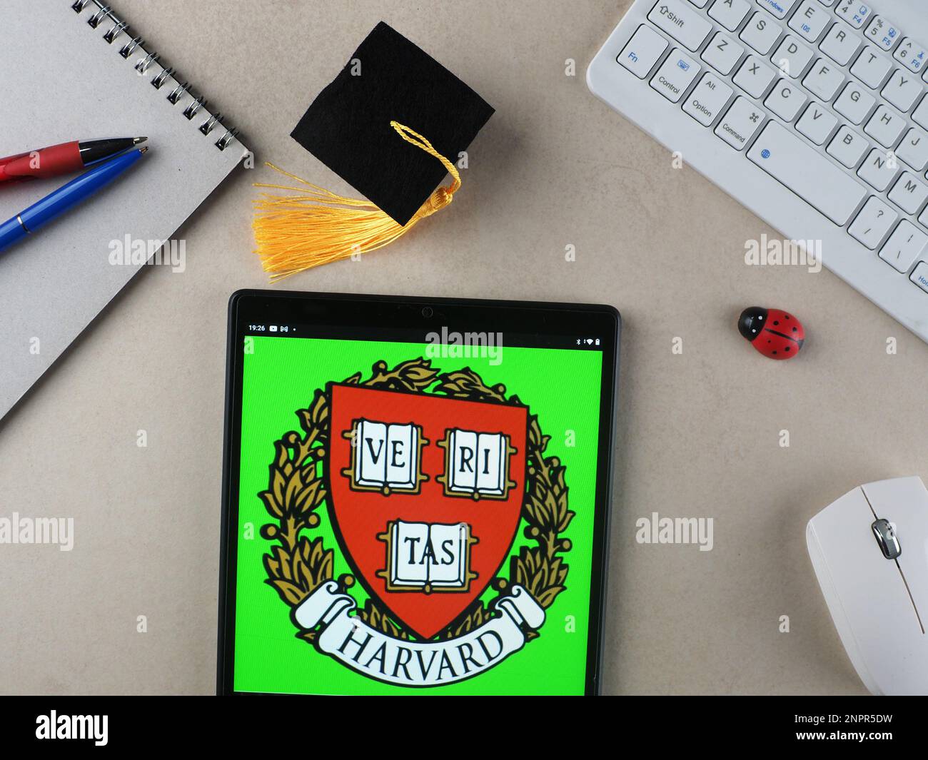 In this photo illustration, Harvard University logo seen displayed on a ...