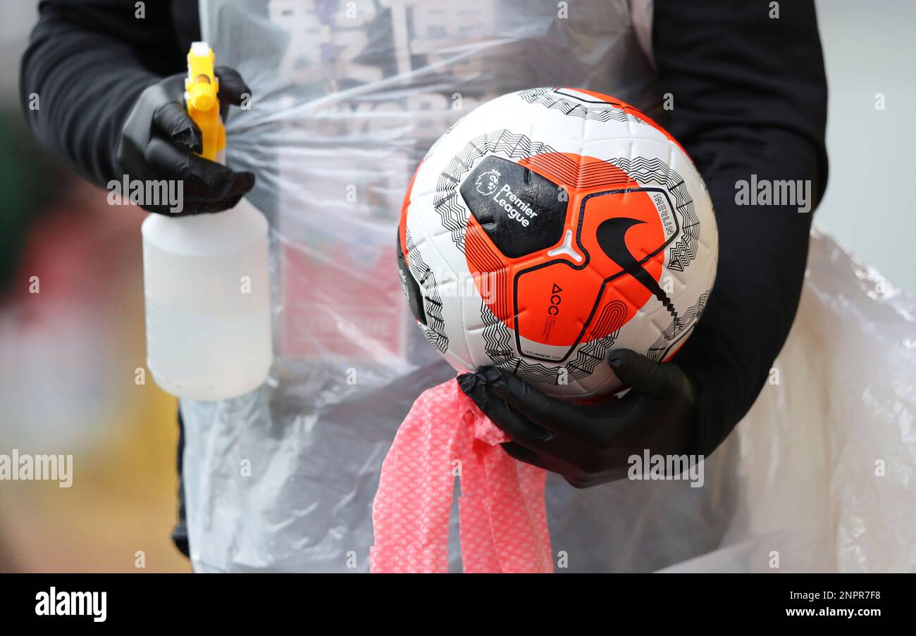 A ball is cleaned by ground staff during the English Premier League ...