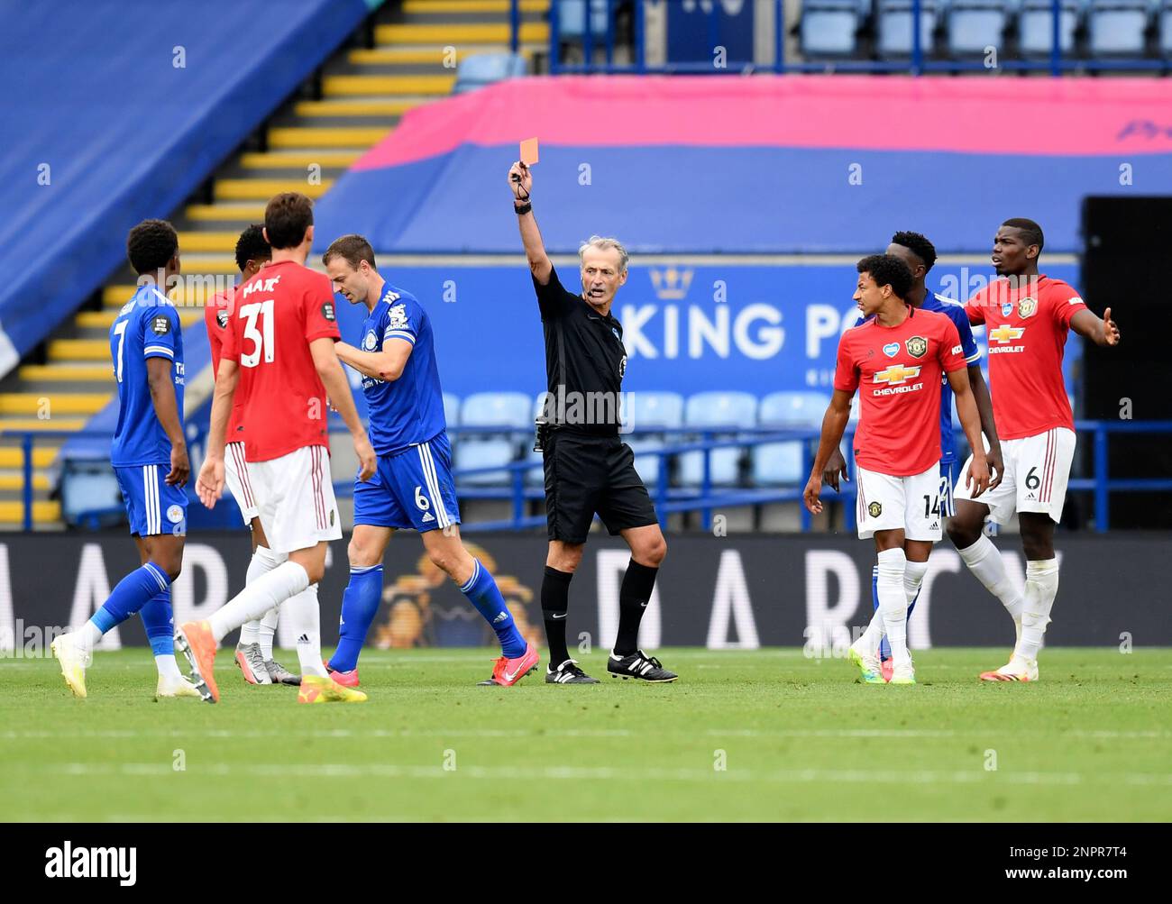Referee Martin Atkinson, centre, shows a red card to Leicester's Jonny ...