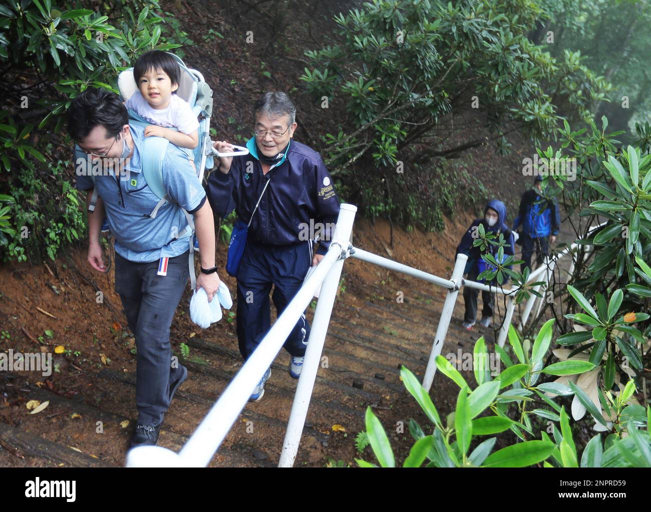 Bereaved family and relatives climb a mountain to pray for the victims ...