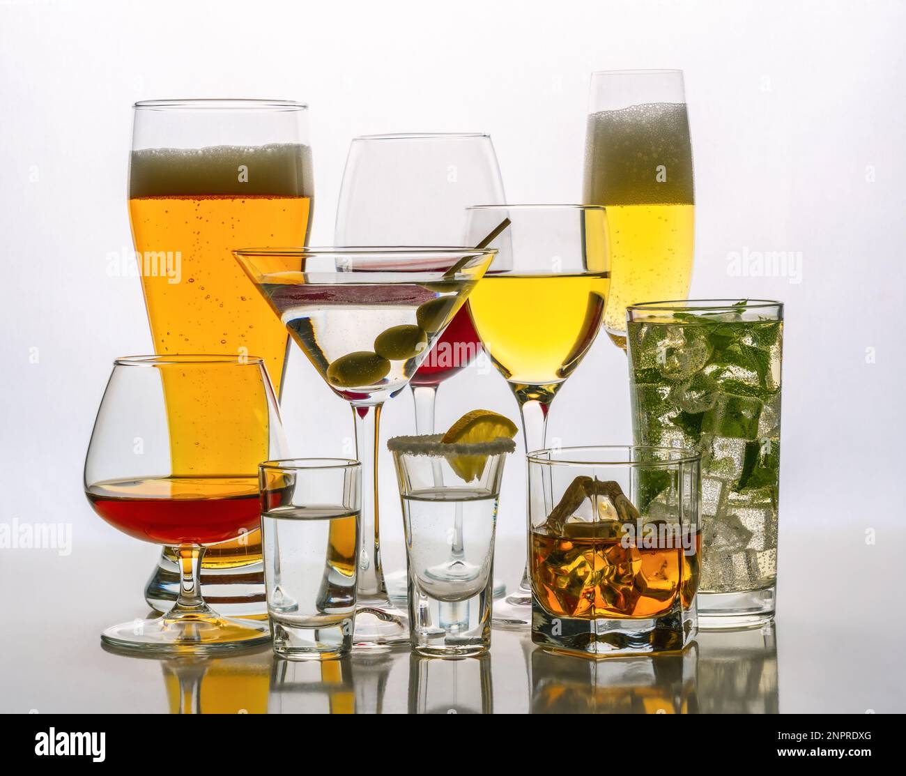 A diverse assortment of alcoholic beverages on a white background in a ...