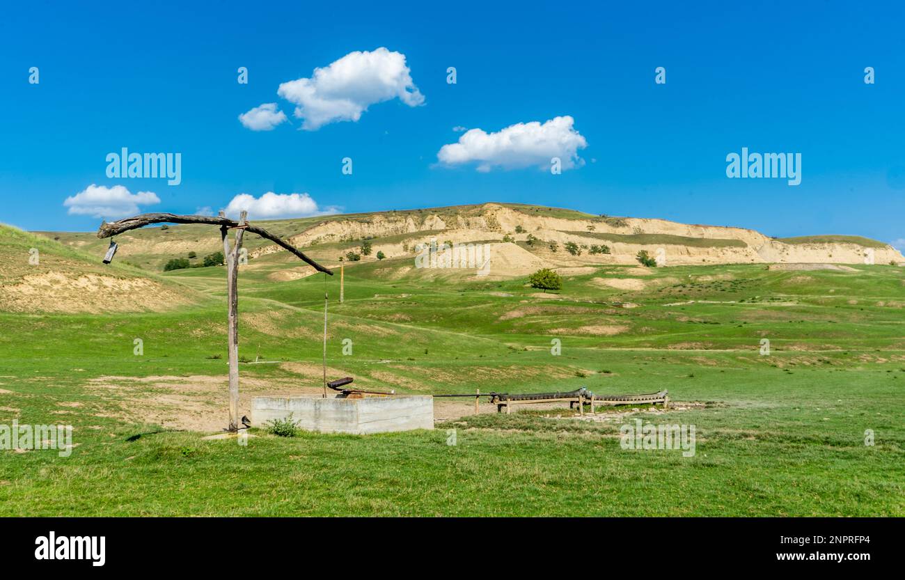 Draw well. Wooden well. well on the field Stock Photo - Alamy
