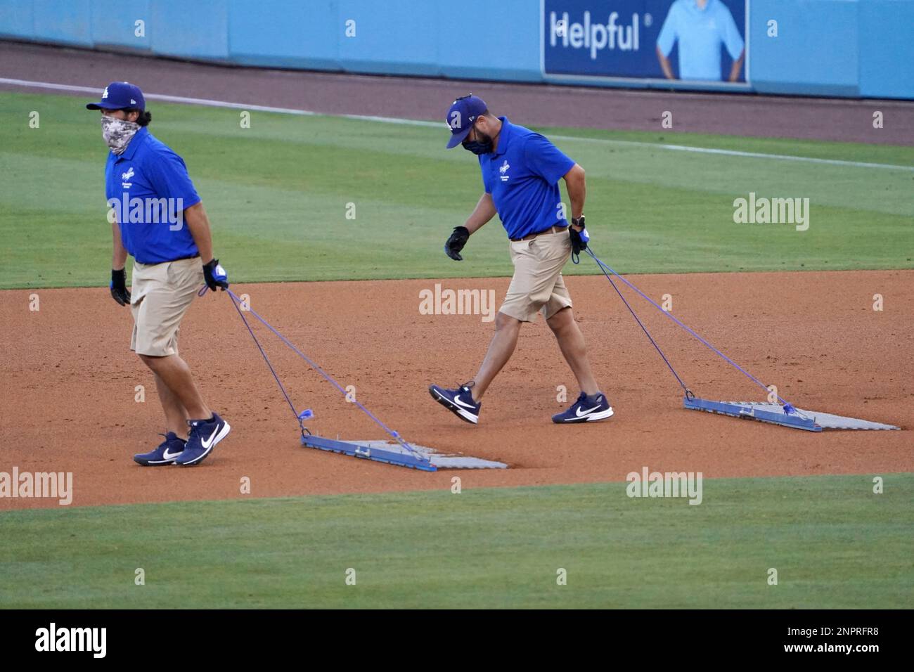 Los Angeles Dodgers grounds crew workers wear face masks during a ...
