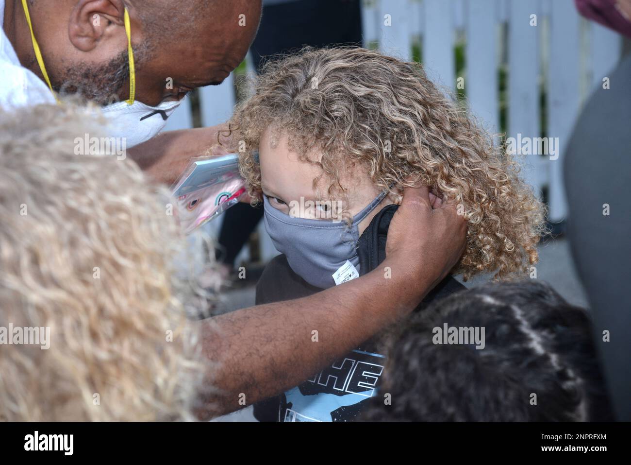 Michael Curtis gets help putting on his mask from his father Richard ...