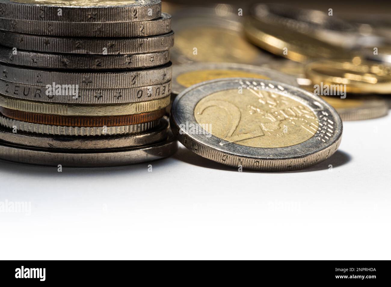 Stack of the coins and Two euro coin with soft focus Stock Photo - Alamy