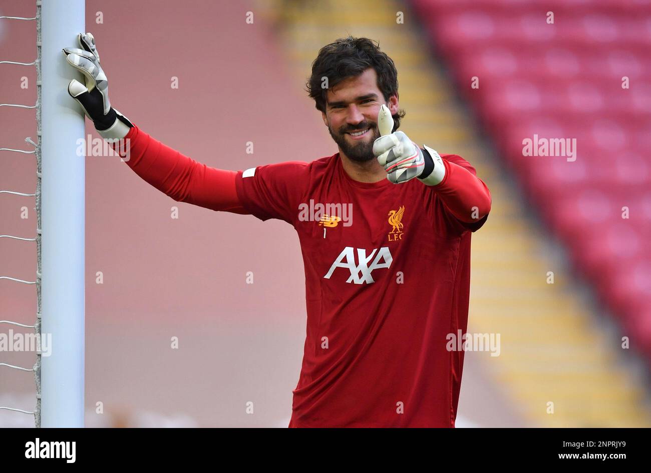 Liverpool's goalkeeper Alisson gestures as he warms-up before the ...