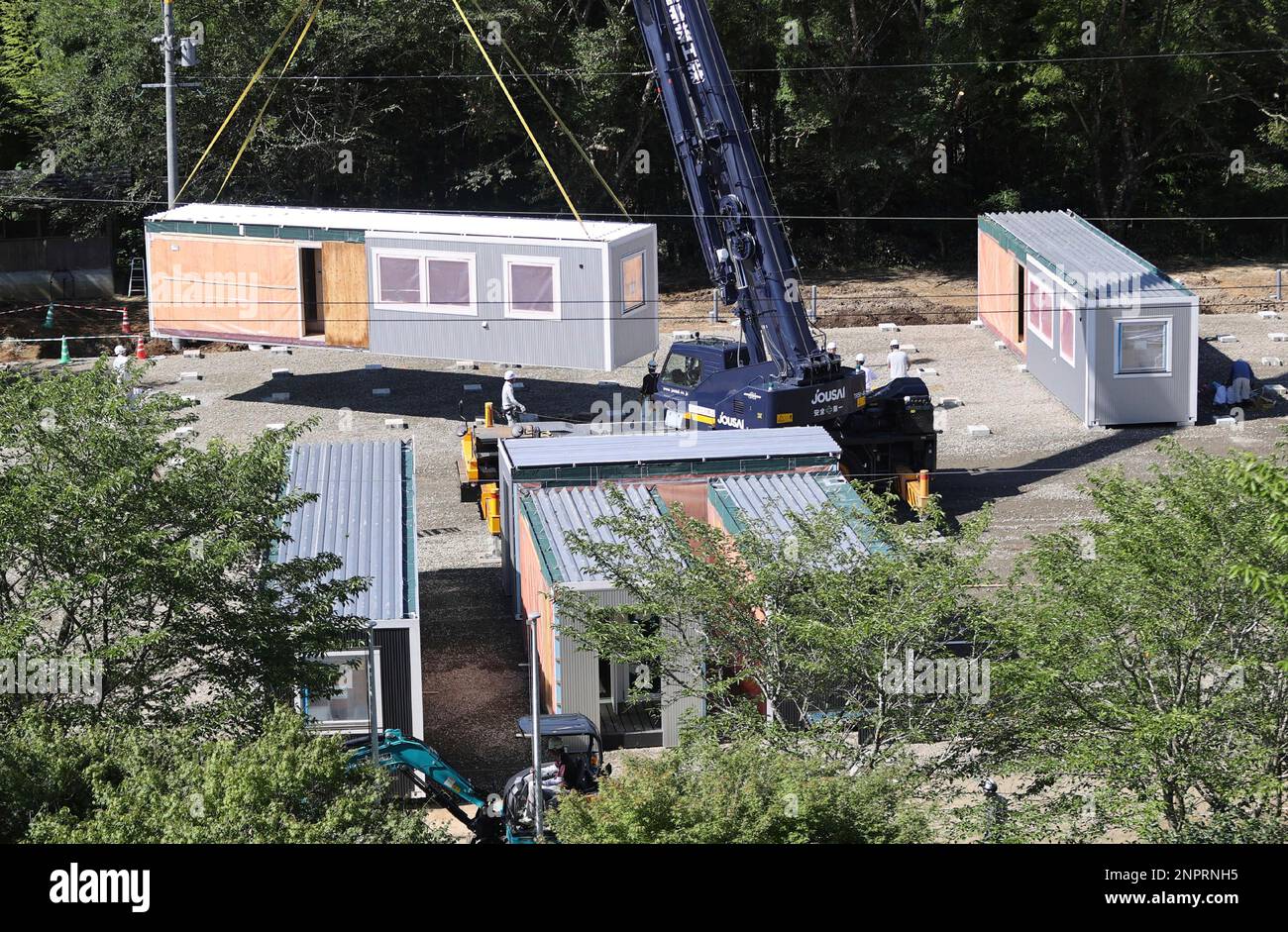 The moving houses are brought to the disaster area in kuma Village ...
