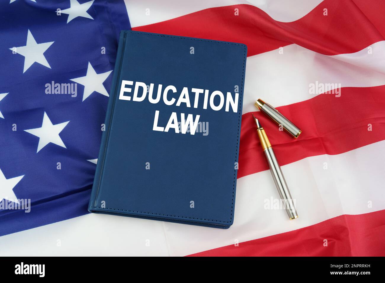 Law concept. On the US flag lies a pen and a book with the inscription ...