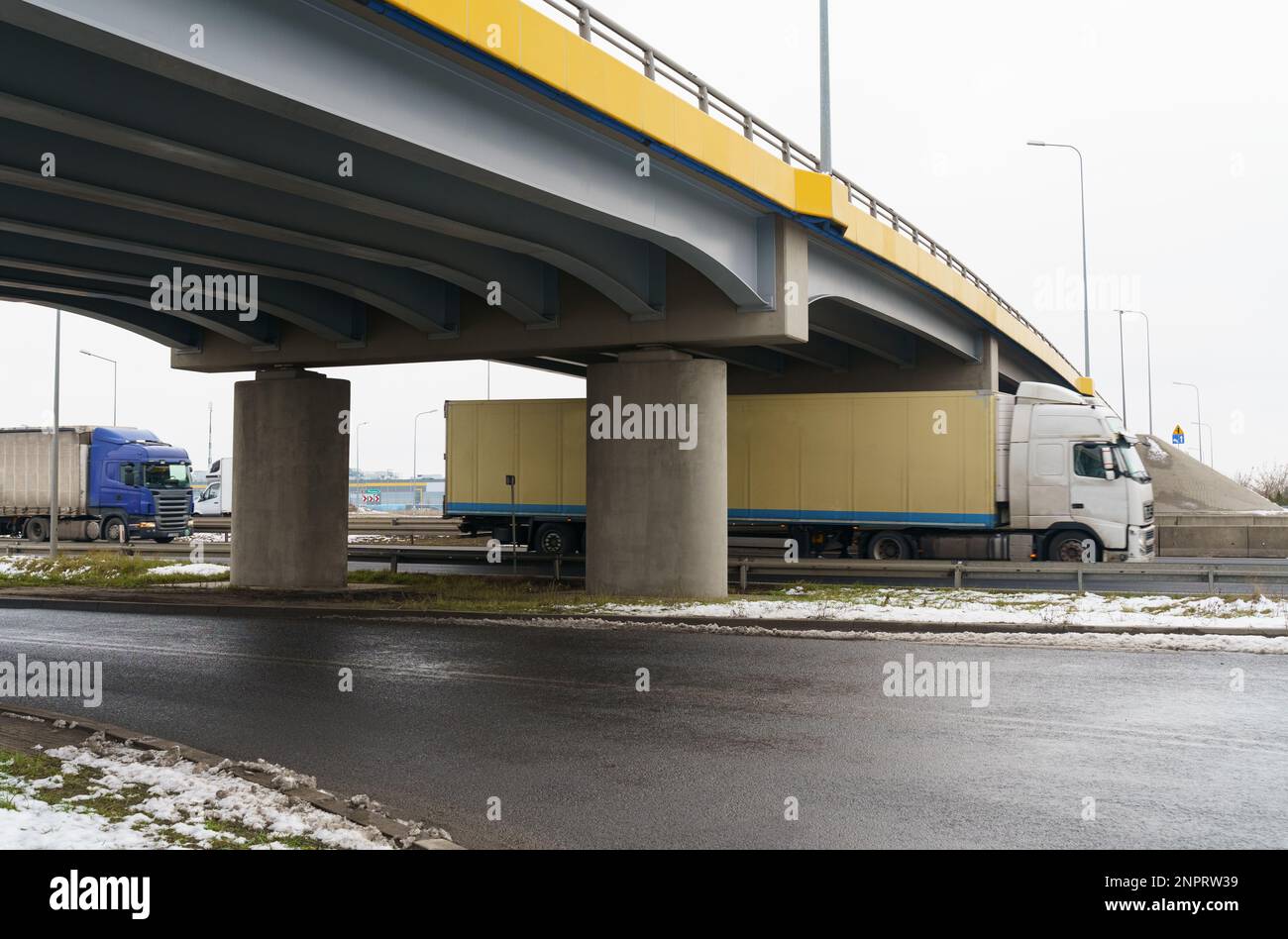 Trucks drive under the transport bridge. Transport logistics Stock ...