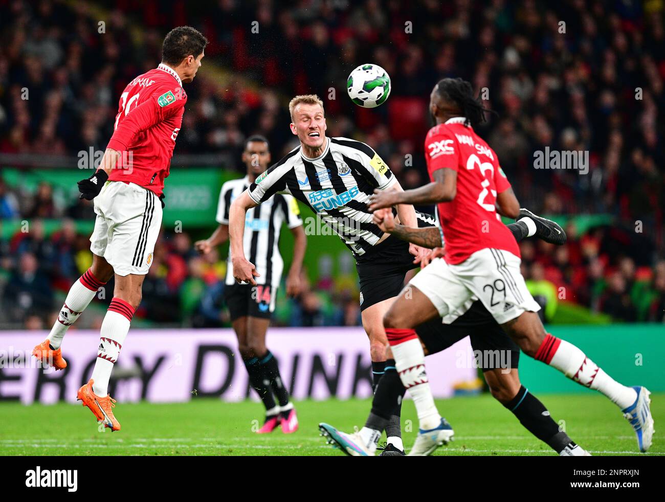 Wembley, London, UK. 26th Feb, 2023. Dan Burn of Newcastle United tries ...