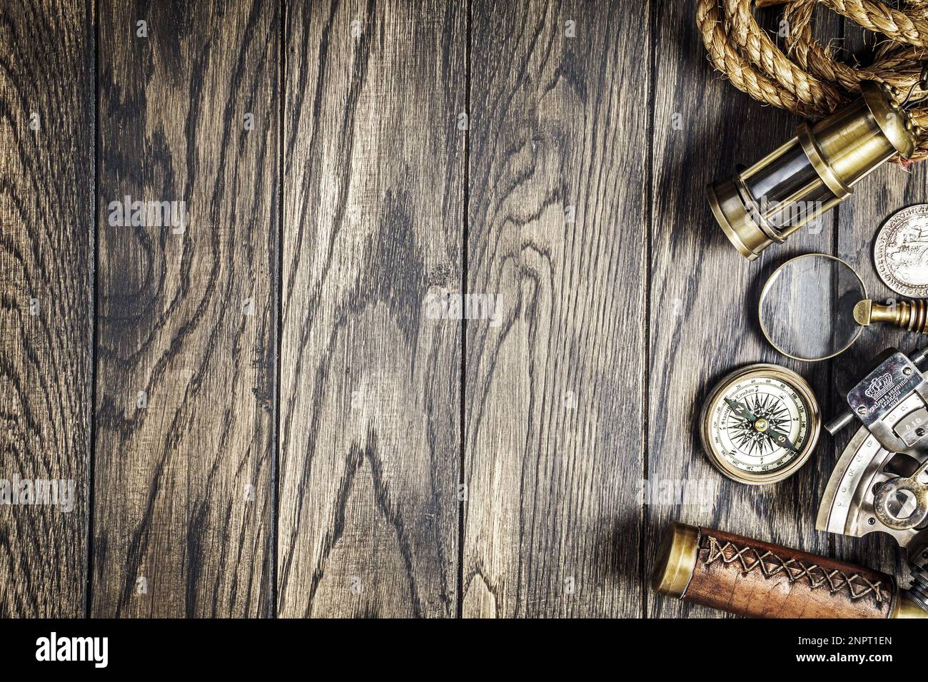 Medieval nautical instruments at right side of oak woodn table, top ...