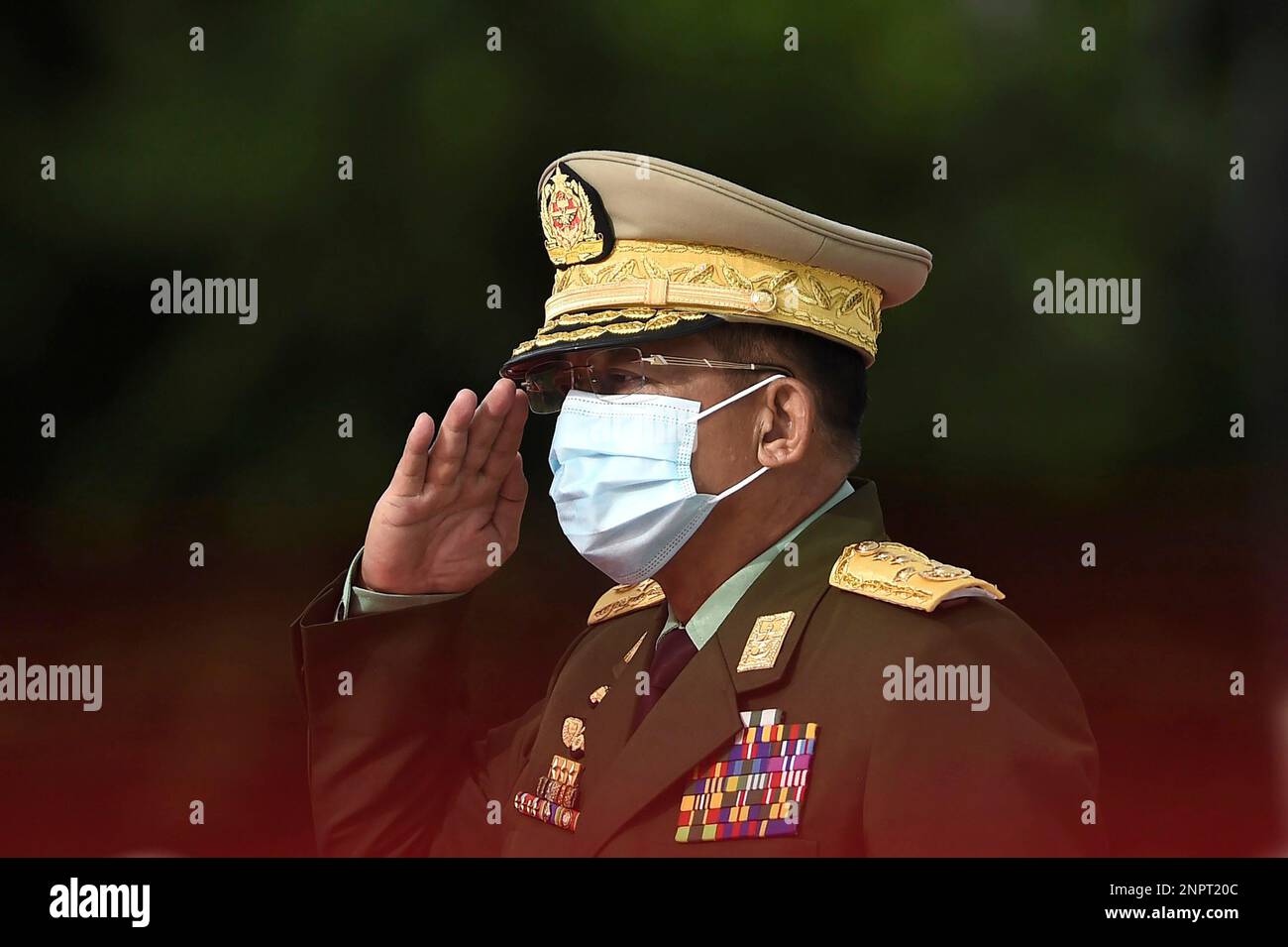 Military Chief, Senior Gen. Min Aung Hlaing wearing face mask salutes ...