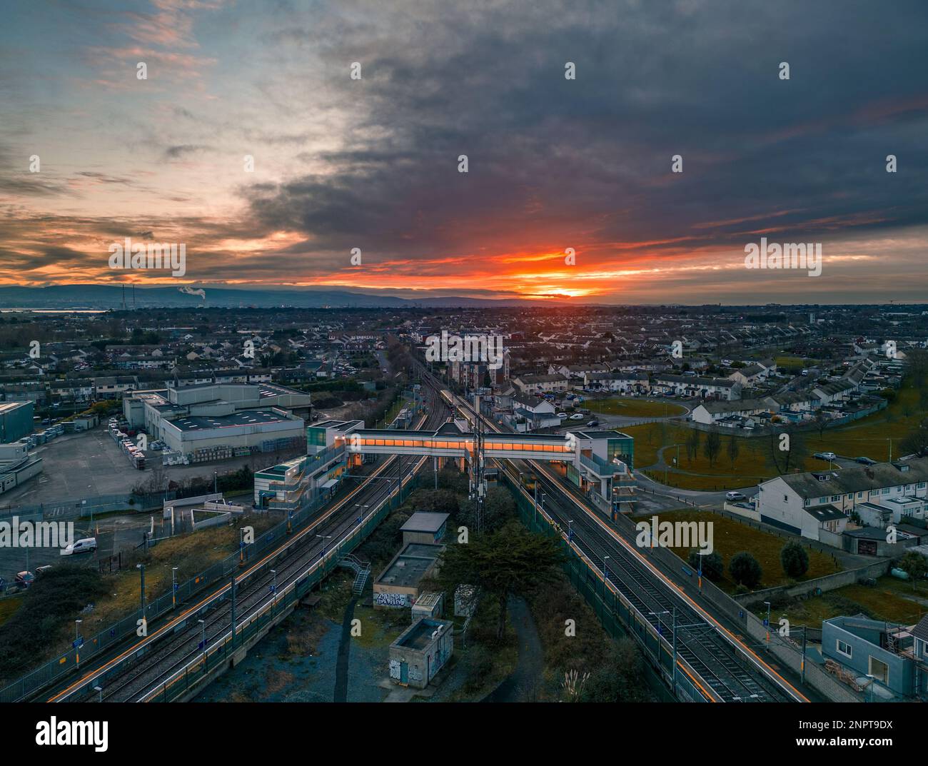 The final colours of sunset at Howth Junction station Stock Photo - Alamy