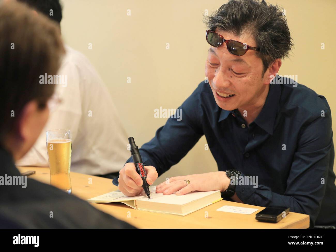 Japanese writer Seishu Hase signs after receiving the Naoki Prize in ...