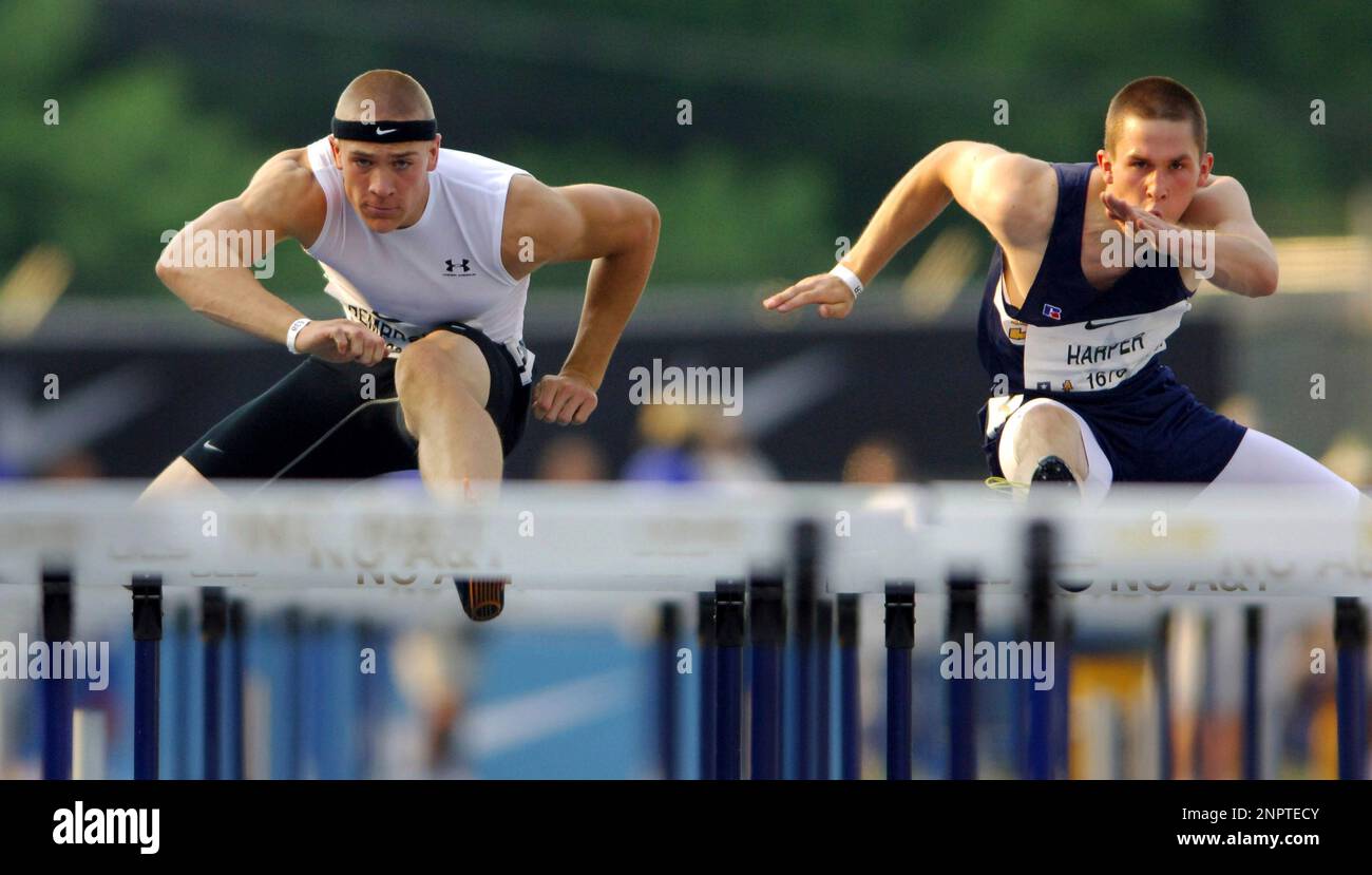 Joshua Hembrough (left) and Zachary Harper duel in a 110-meter hurdle ...