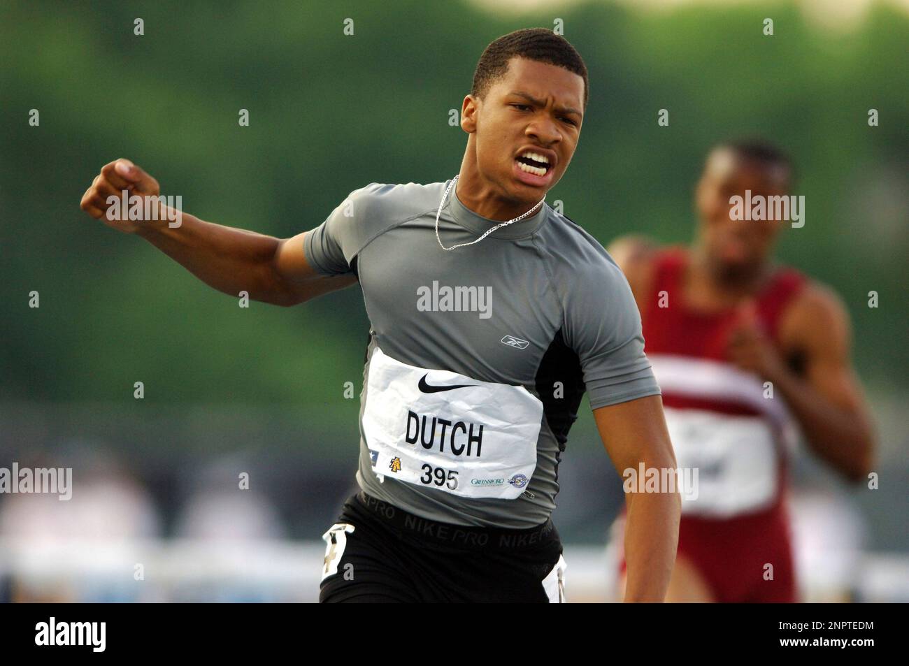 Johnny Dutch of Clayton High (N.C.) celebrates after winning the 110 ...