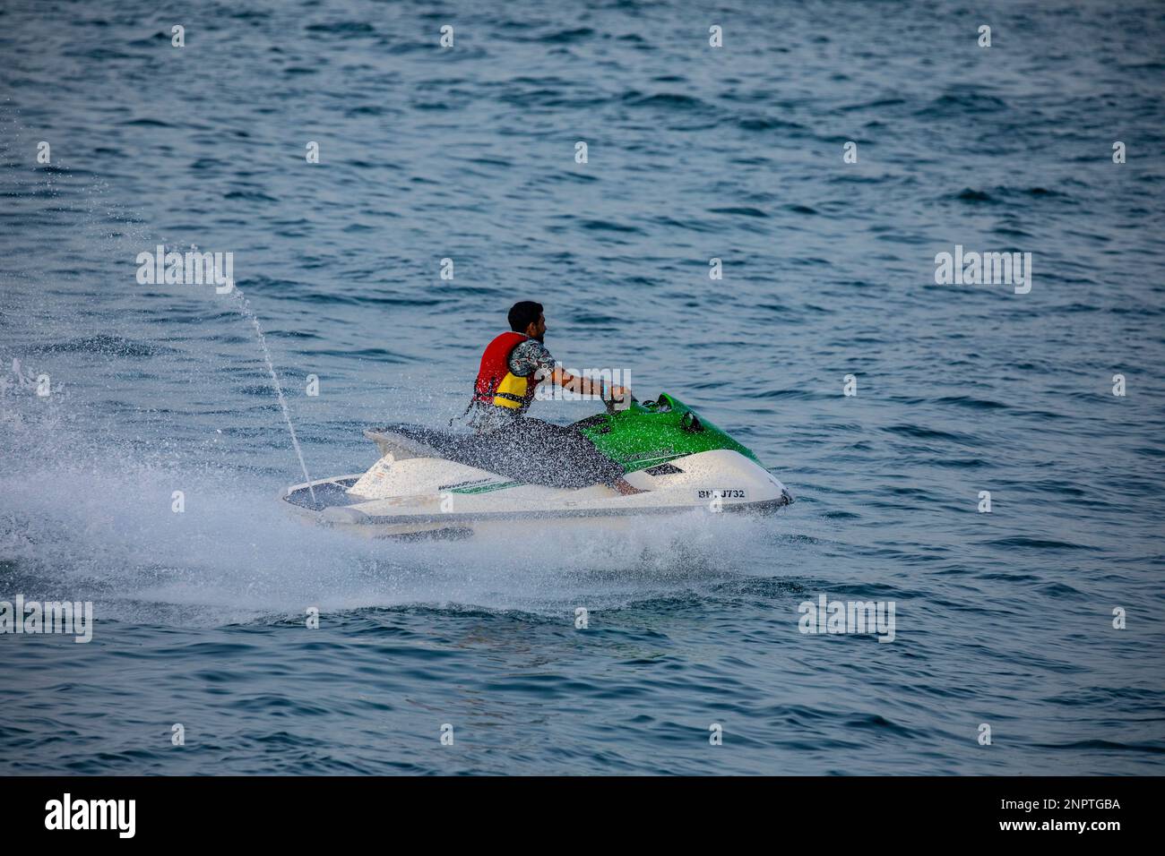A man with a jet ski or water scooter or personal watercraft in Persian ...