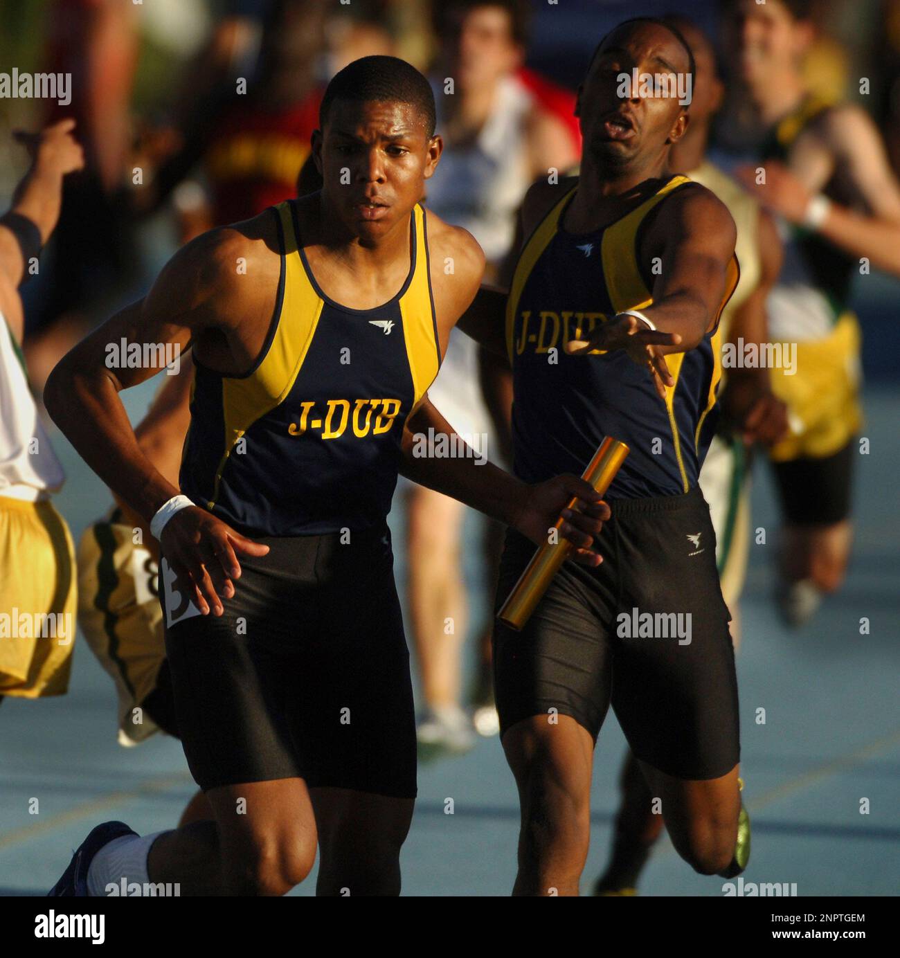 Tim Sebastian takes handoff from Ennis Jones on the third leg of ...