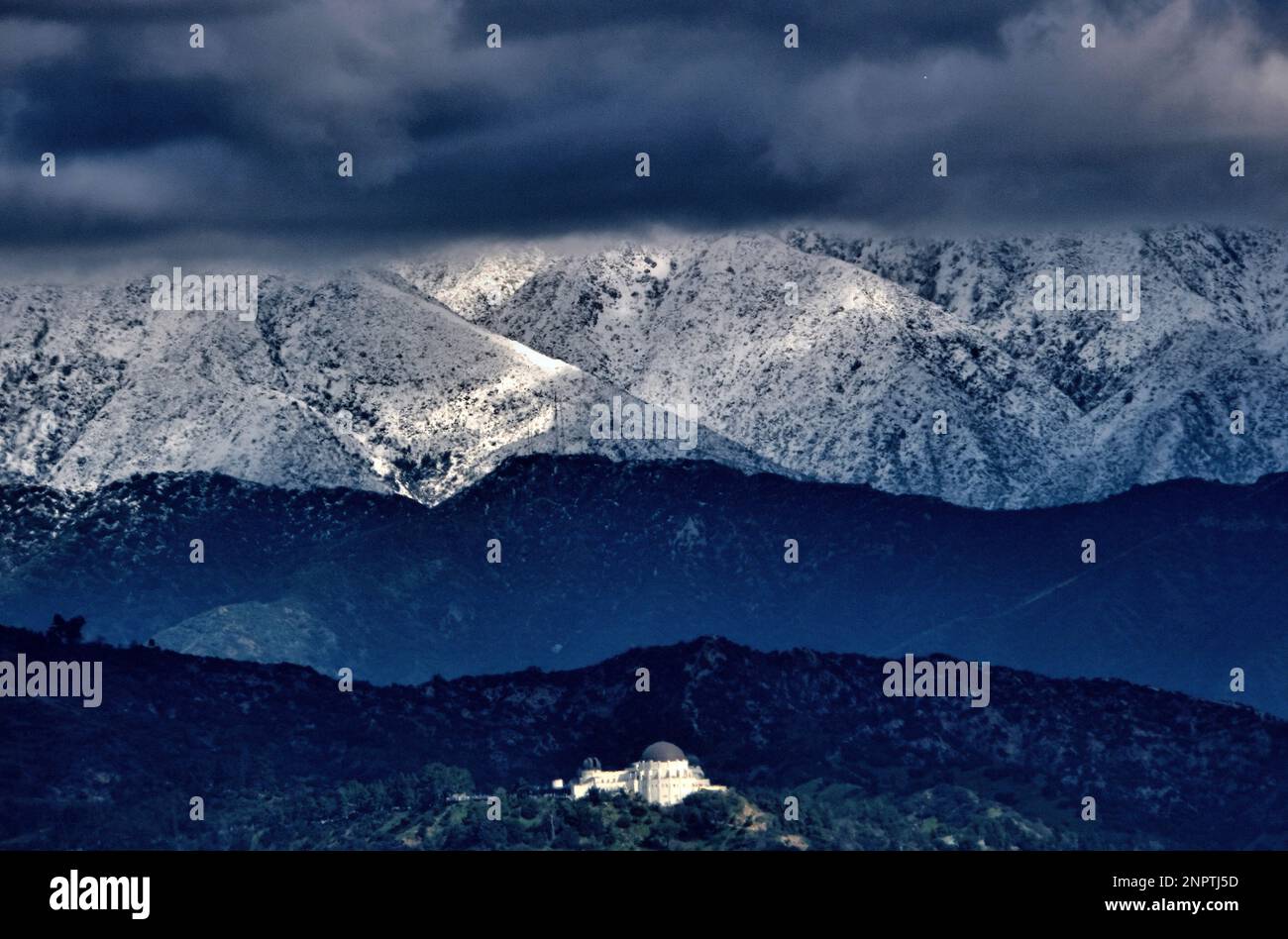 Storm clouds and snow are seen over the San Gabriel mountain range ...