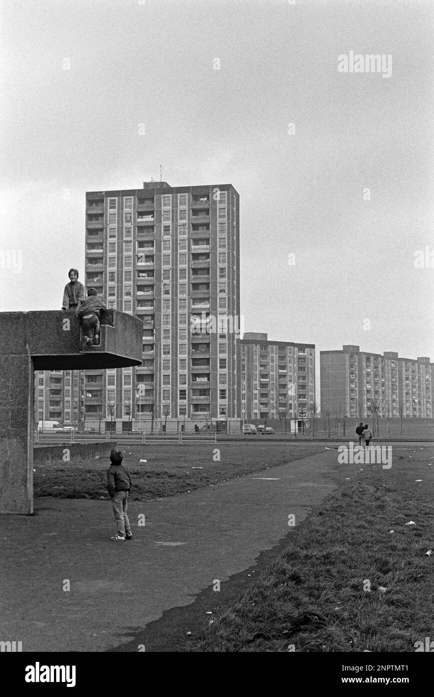 Boys climbing awning, entrance area of a tower block, Ballymun, Dublin ...