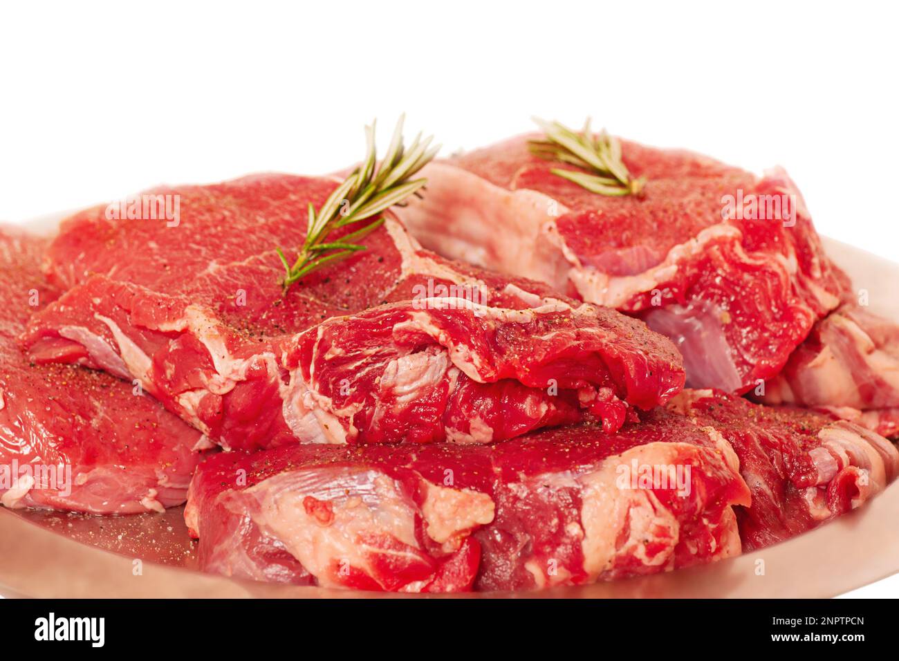 Beef steaks on a metal plate. Meat for cooking with rosemary isolated ...