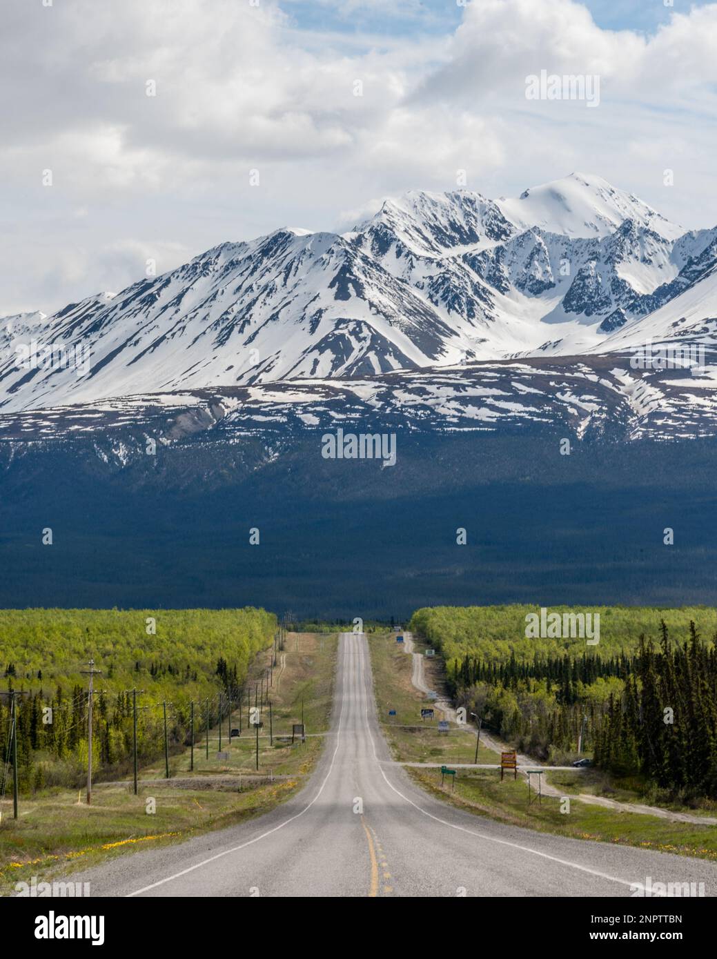 Alaska Highway driving into Haines Junction town in spring time with ...