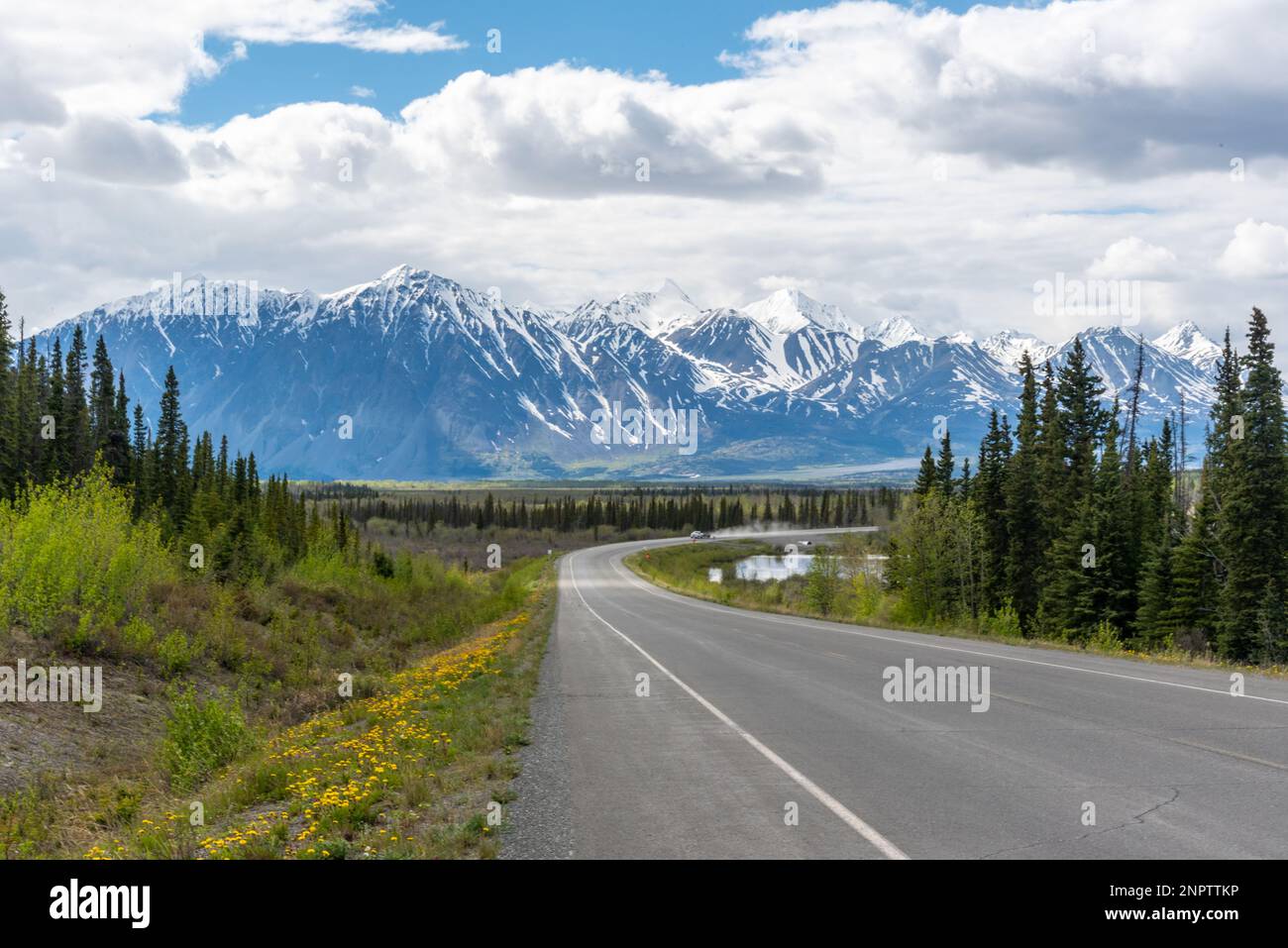 Alaska Highway driving into Haines Junction town in spring time with ...