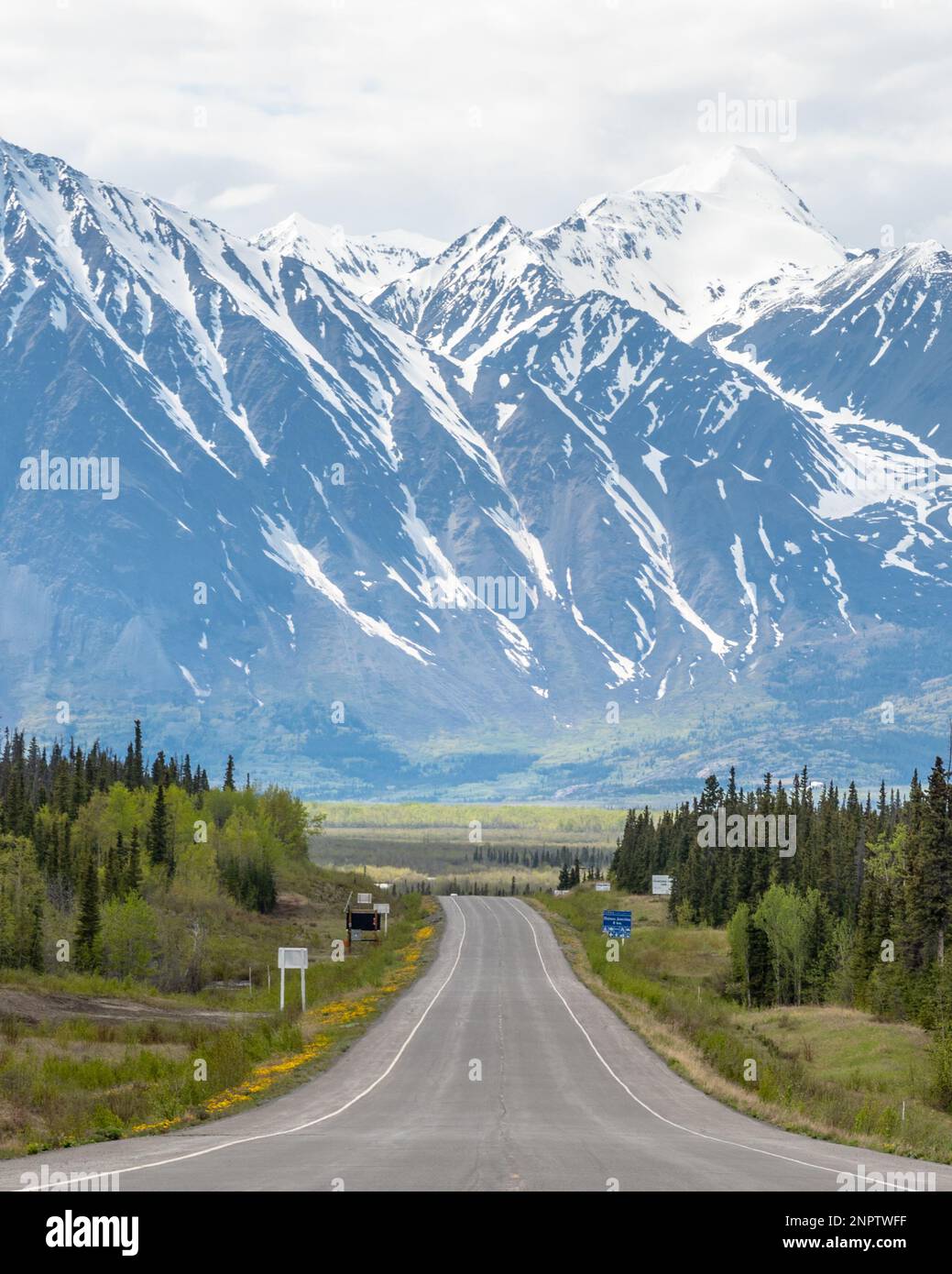 Alaska Highway driving into Haines Junction town in spring time with ...