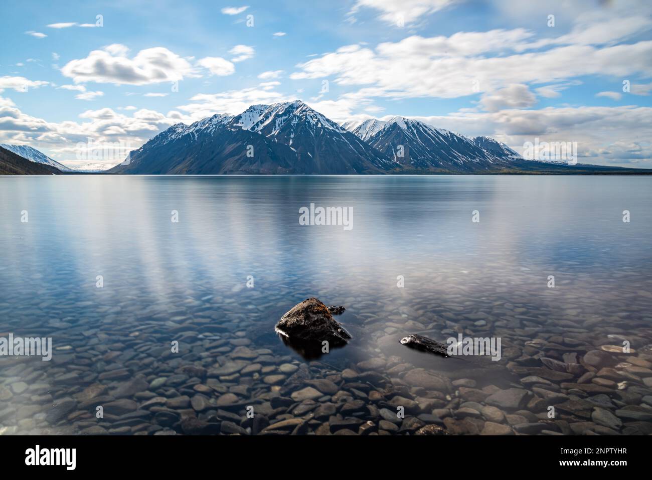 Northern Canadian views in spring time with clouds and snow capped ...