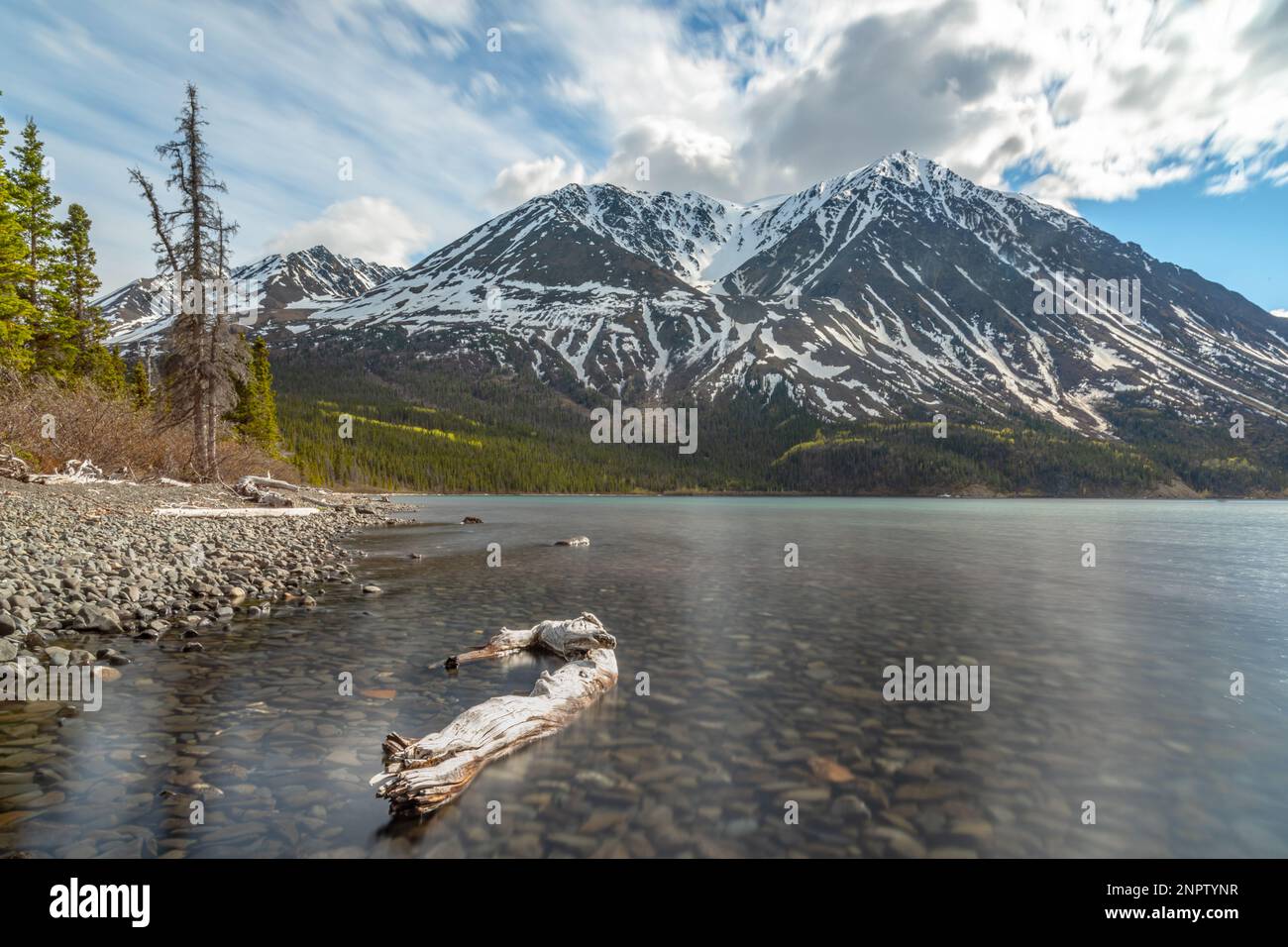 Northern Canadian views in spring time with clouds and snow capped ...