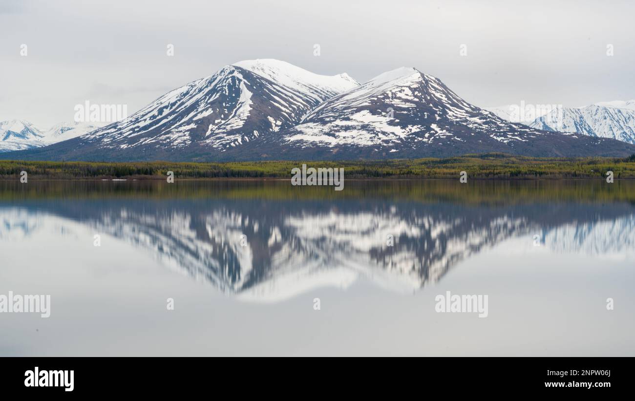 Northern Canadian views in spring time with clouds and snow capped ...